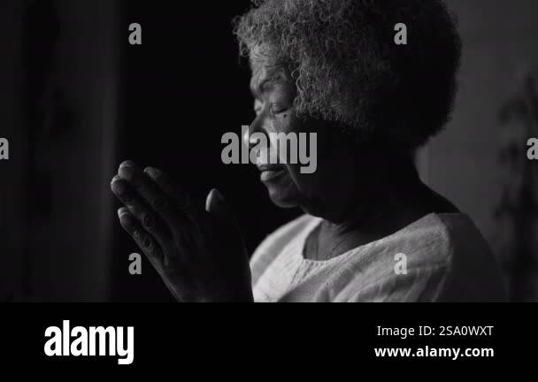 One devoted Religious black senior woman PRAYING to GOD at home by ...
