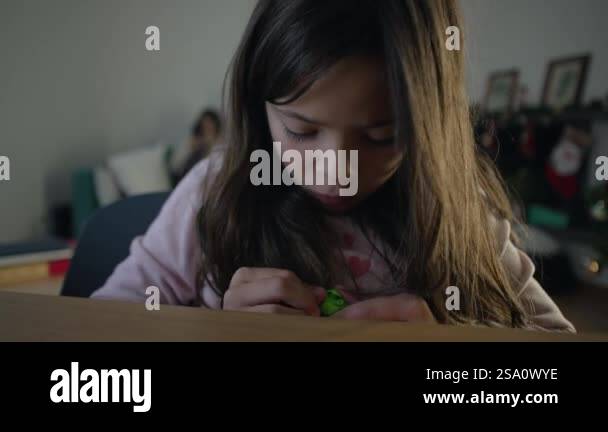 Concentrated Child putting pieces of toy together, little girl ...