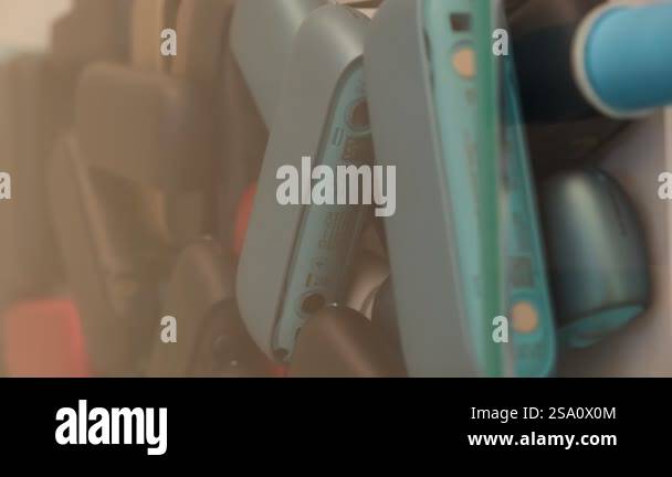 A collection of used IQOS electronic cases in various colors, stacked ...