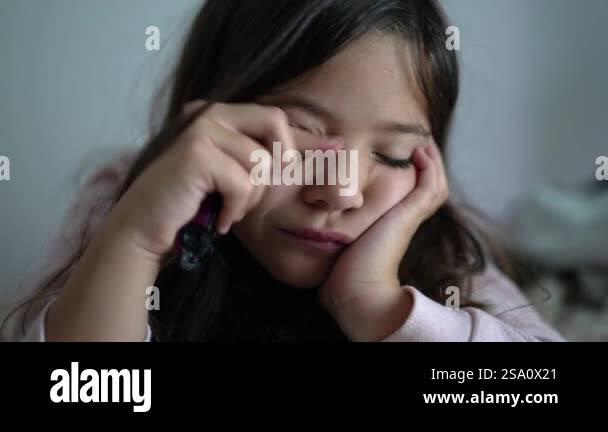 Tired little girl rubbing eye with finger, exhausted weary female child ...