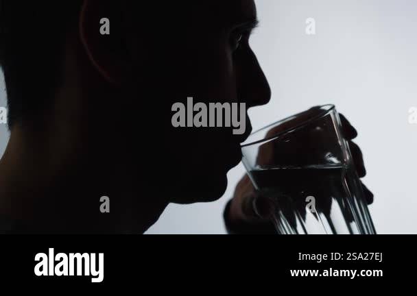 Man drinking refreshing water from a clear glass Stock Video Footage ...