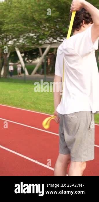 Unrecognizable man using resistance elastic band to exercise in a ...