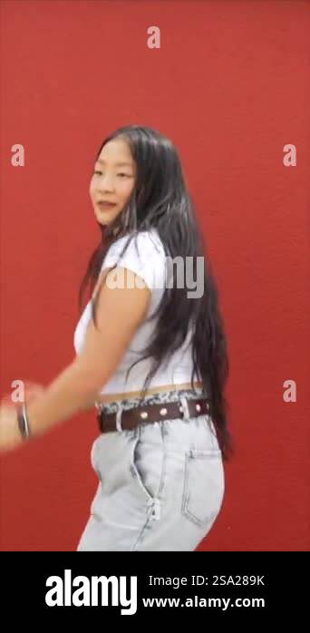 Asian young smiling woman waving hands dancing K-pop urban dance ...