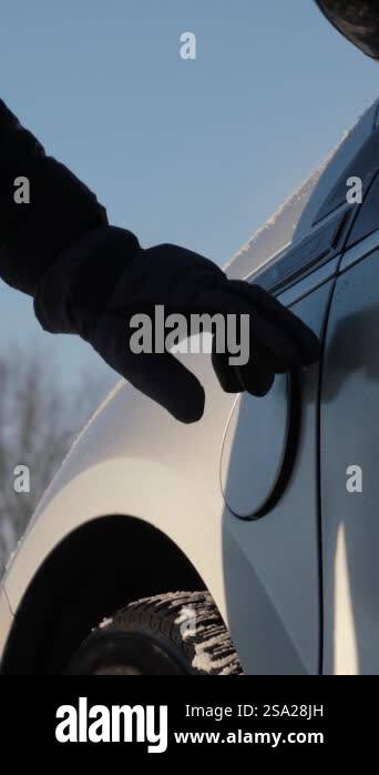 Vertical video of gloved hand inserts power connector into electric ...