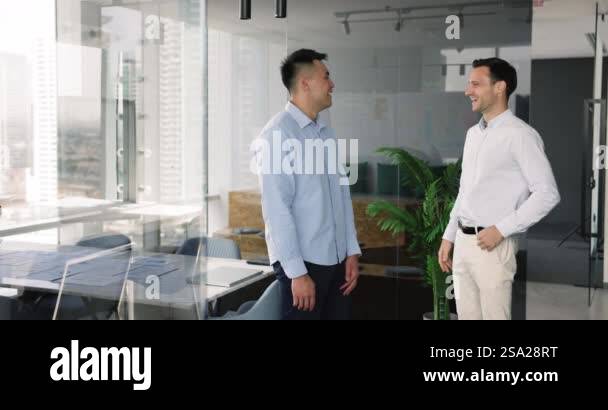 Two confident male business partners giving handshake after ...