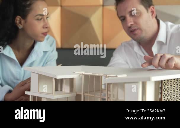 Professional architect engineer team discuss about house model ...