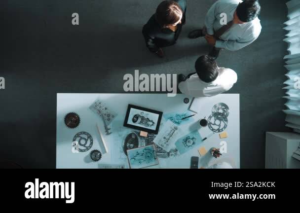 Top down view of smart engineer talking about turbine engine design ...