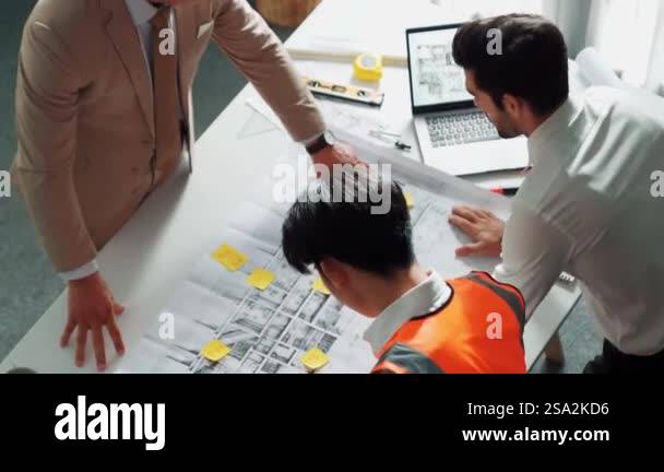 Top view of professional architect engineer team inspect house model while manager holding ...