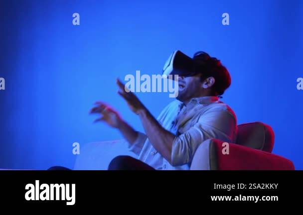 Excited caucasian man sitting at sofa with fear while watching horror ...