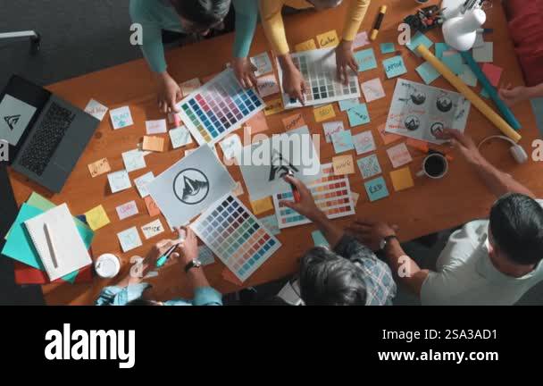 Top down view of smart designer explain and brainstorming idea for logo ...