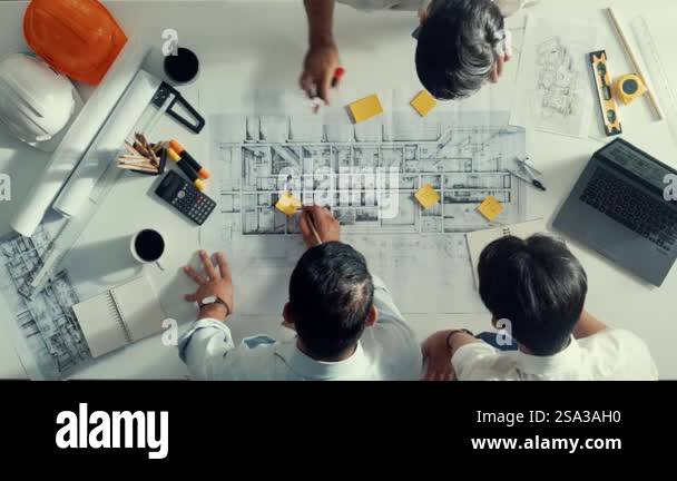 Top down aerial view of interior designer writing at sticky note while ...