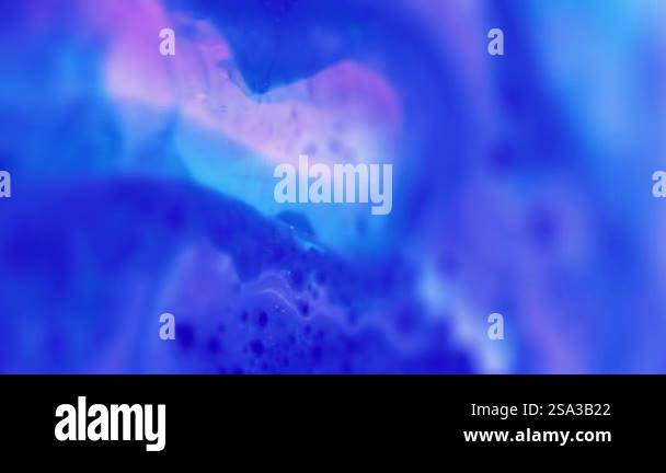 Vertical video. Sparkling serum. Wet foam. Defocused neon blue pink ...