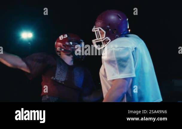 A dramatic moment as two American football players face off, helmets ...