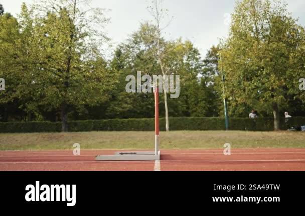 Female Athlete is Running Towards an Obstacle, Hurdling, Jumping Over ...