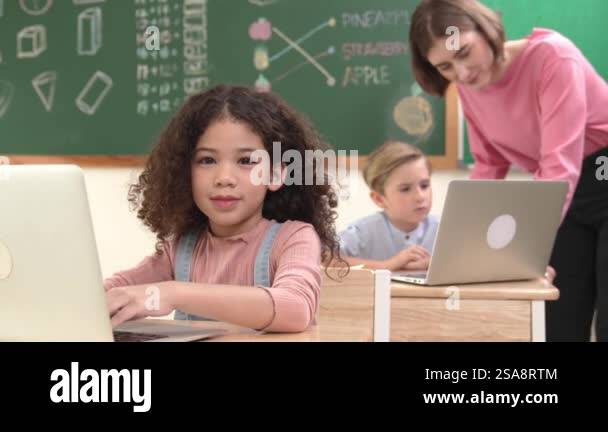 Attractive girl coding prompt while looking at camera at STEM class ...