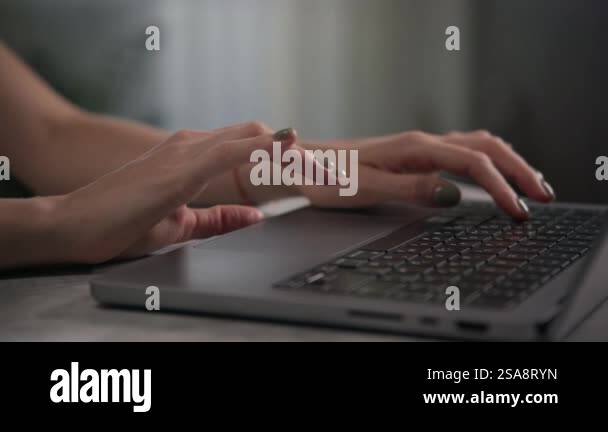 Close-up of a womans hands with green nails typing and browsing online ...