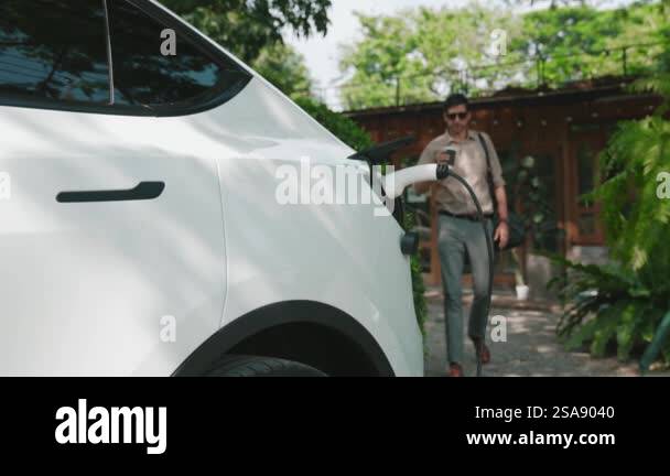 Slow motion man and sustainable urban commute with EV electric car ...