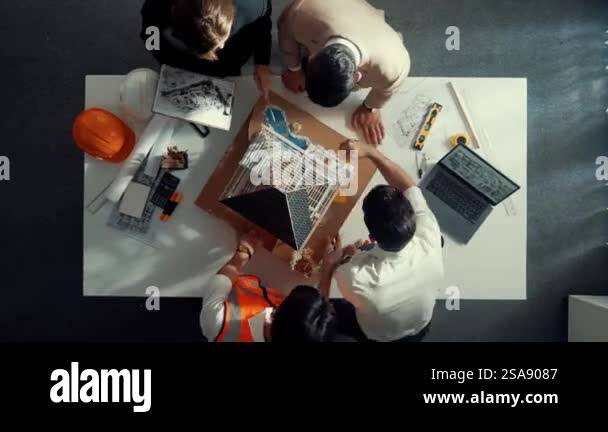 Time lapse of smart architect engineer team inspect house model while ...