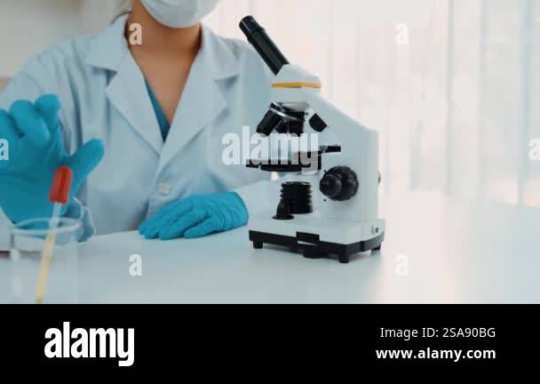 Scientific laboratory researcher drop liquid sample on microscopic ...