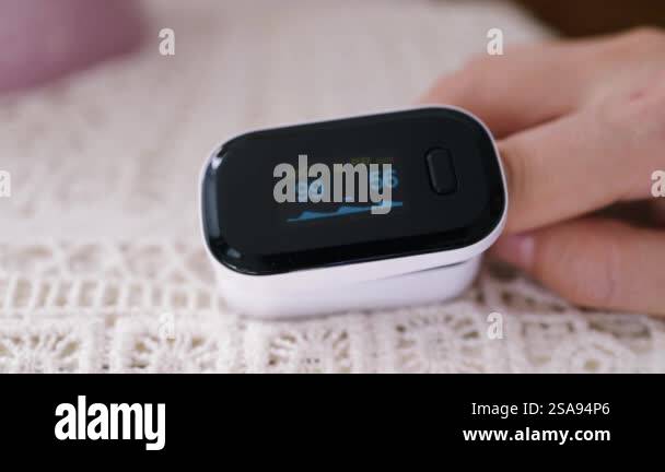 Woman Measures Pulse and Oxygen Saturation Using a Pulse Oximeter at ...