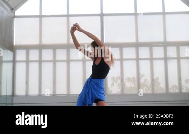 A medium view of a woman performing a sensual contemporary dance in a ...