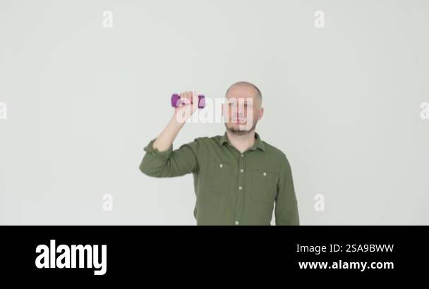 Man demonstrating proper technique of lifting dumbbells overhead during ...