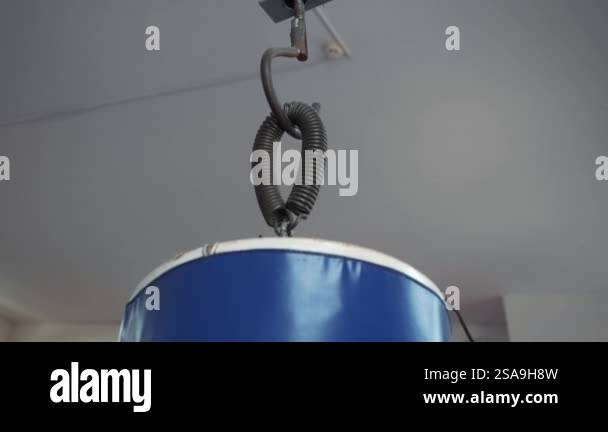The boxing bag swings slowly on a spring. High quality 4k footage Stock ...