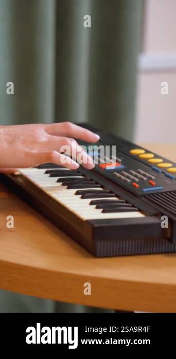 Female musician practises playing keyboard by recording intricate ...