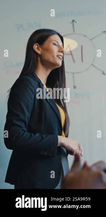 Vertical Screen: Businesswoman presenting a strategy focused on ...