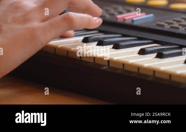Female musician practises playing keyboard by recording intricate ...
