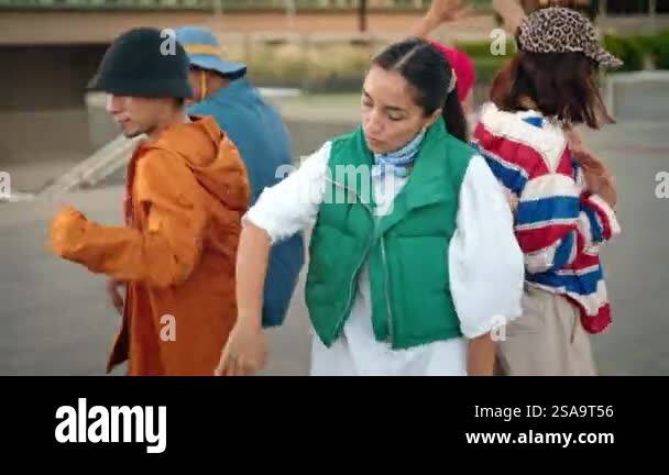 Energetic multi ethnic dancers moving and grooving in choreography with ...