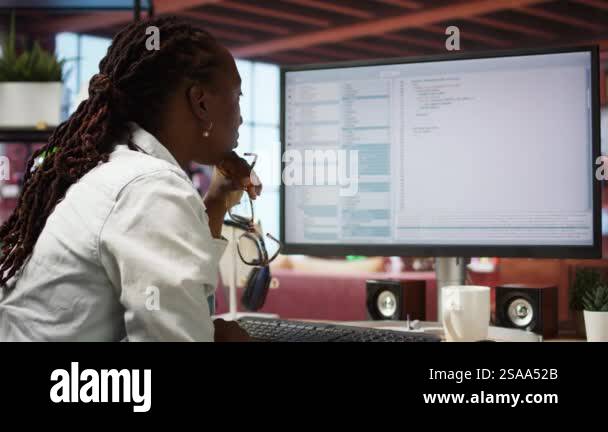 Disappointed engineer in home office looking at UI on computer monitor ...