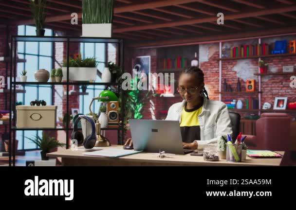 Freelancer in home office opening laptop, starting working on tasks. Remote employee using ...