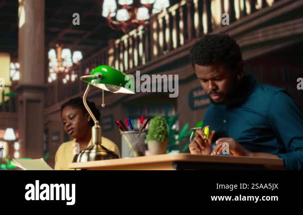 Black university student highlighting relevant phrases to learn the ...