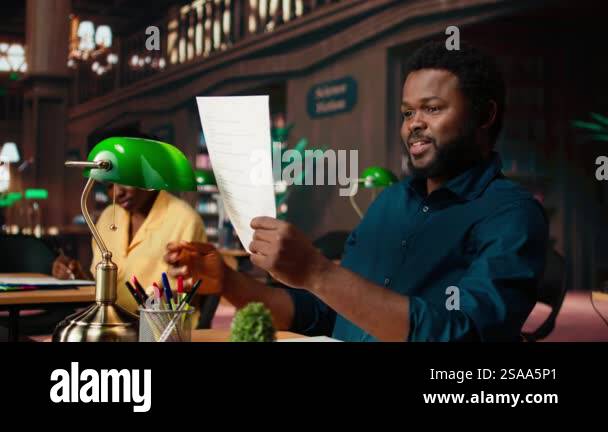 Black student rehearsing lines from the script for drama school course ...