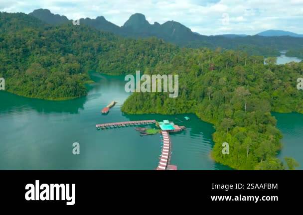 Lush greenery surrounds tranquil waters with villas perched over Cheow ...