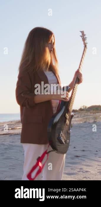 Girl playing bass guitar in the nature near the beach Stock Video ...