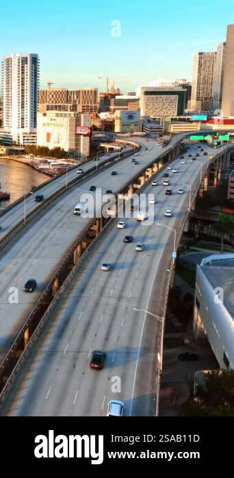 Flying above the highways and cars running by. Lovely view of sunny ...