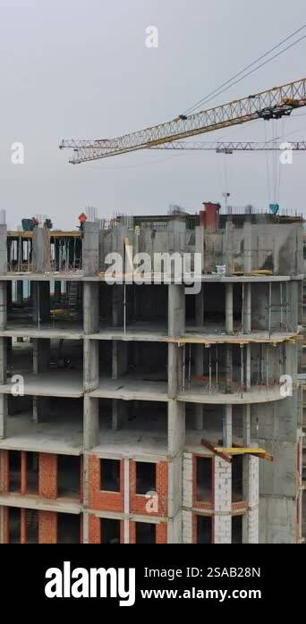 New construction site in the city. Two big cranes constructing the ...