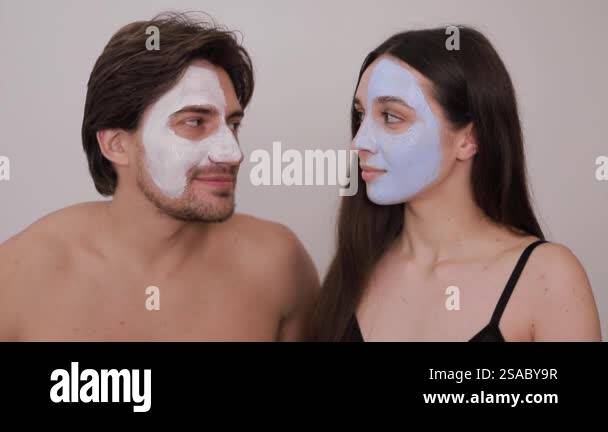 A couple sharing quality time while enjoying a playful skincare session ...