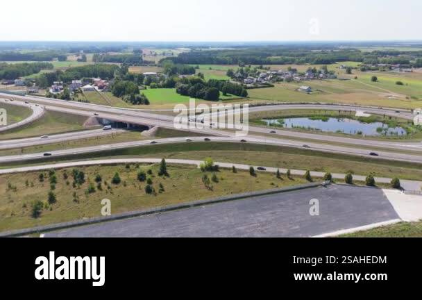 Drone footage of a highway interchange in a rural region of Poland. The ...