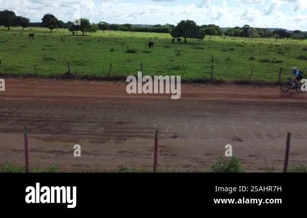 Middle aged man riding a mountain bike in the Brazilian countryside on ...