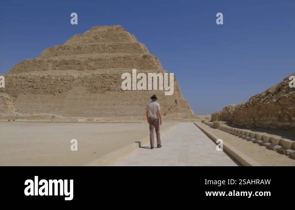 A slow-motion video of a tourist walking towards the iconic Djoser ...