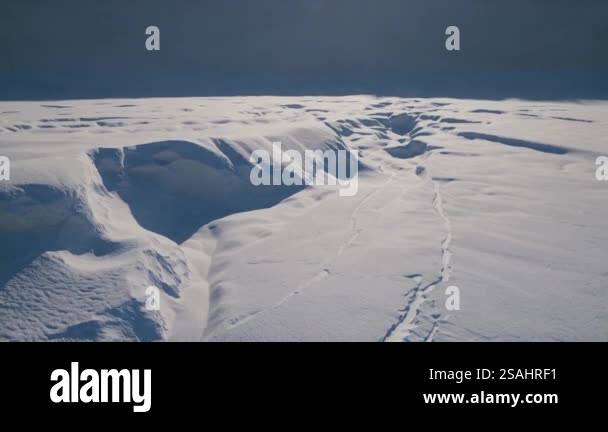 A stunning view of a vast, snowcovered glacier with deep crevasses and ...