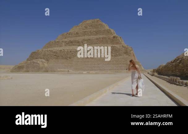 A slow-motion video of a woman tourist walking gracefully towards the ...