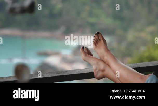 A person is seen resting comfortably with their feet propped up on a ...