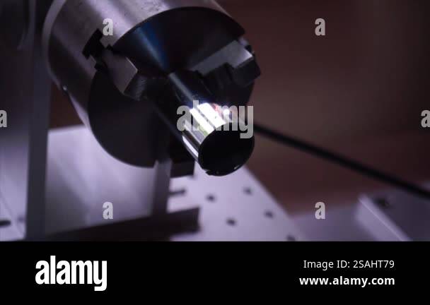 A detailed close-up of a laser engraving process on a reflective ...