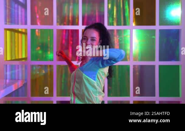 Young beautiful hipsters moving to freestyle music at night club with ...