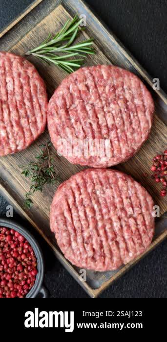 Fresh raw ground beef burger patty with salt and spices on textured ...