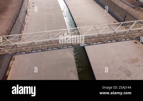 An aerial shot captures a bridge gracefully crossing a canal, which is ...